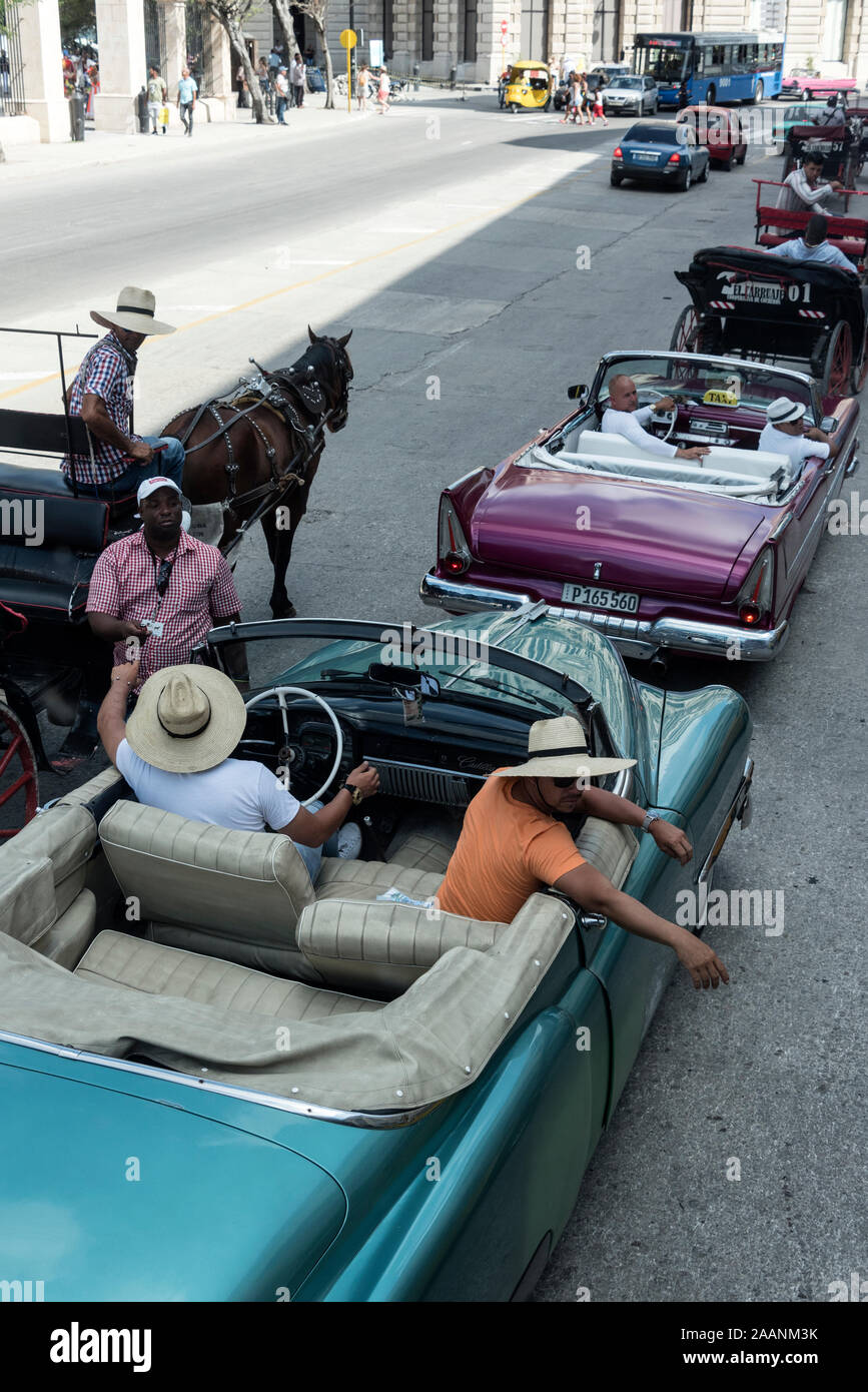 A fleet of American classic cars and horse drawn carriages, waiting for ...