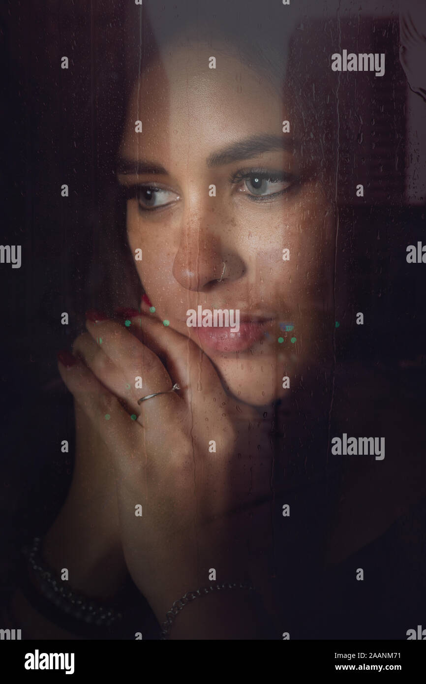 Elegant woman behind the window on a rainy day Stock Photo - Alamy