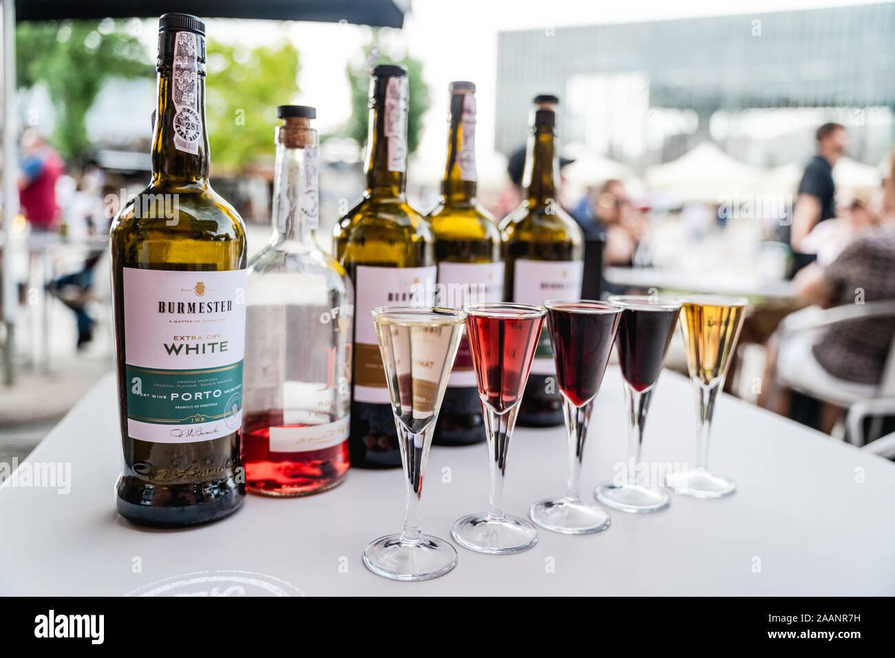 Burmester port selection poured into glasses with the bottles of port ...