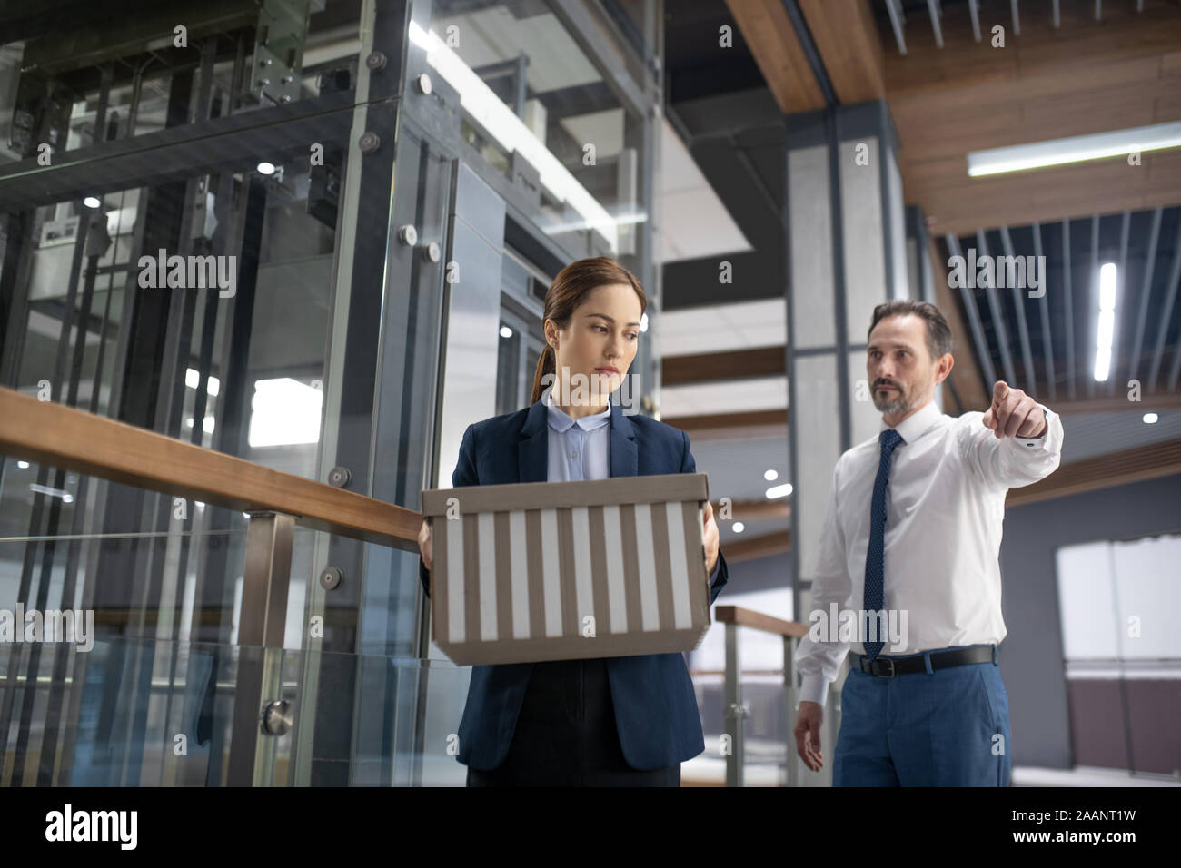 Angry boss shouting and firing young female office worker Stock Photo ...