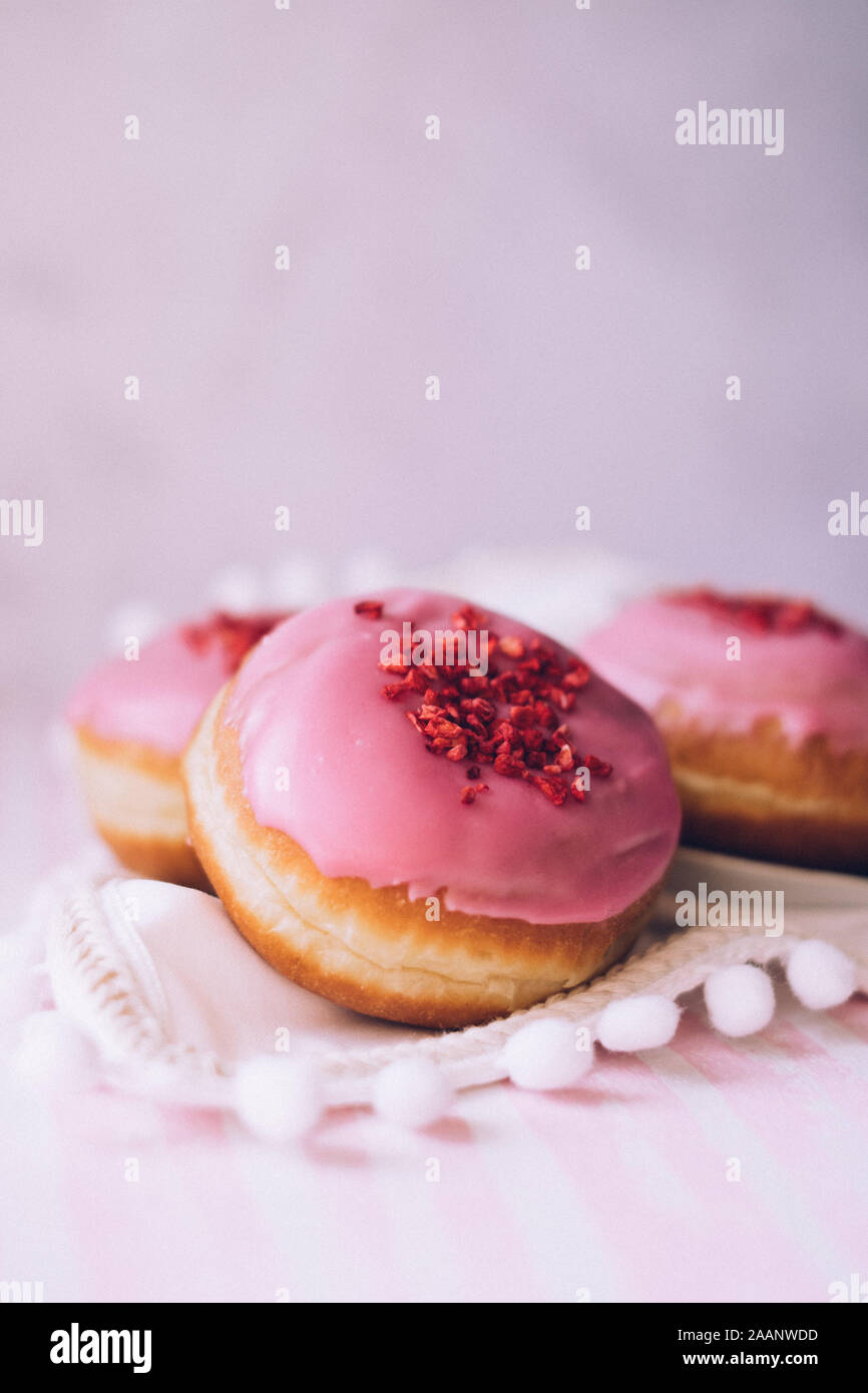 Pink raspberry doughnuts Stock Photo - Alamy