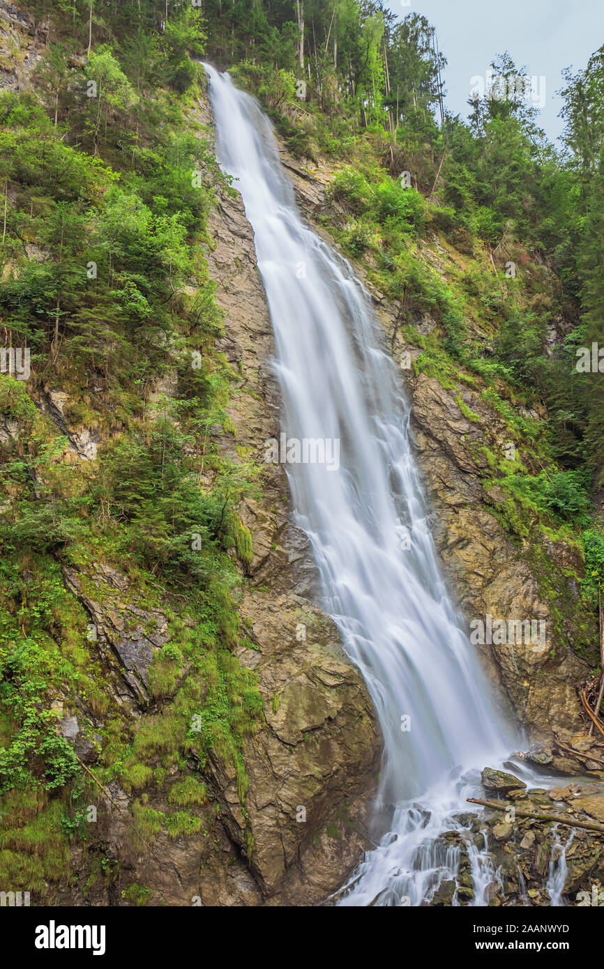 Standing at the base of the waterfall at the entrance of the ...