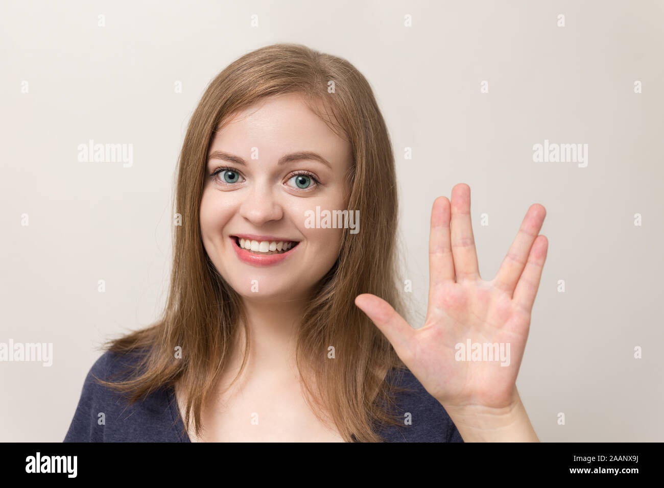 Young caucasian woman shows vulcan greeting Stock Photo - Alamy