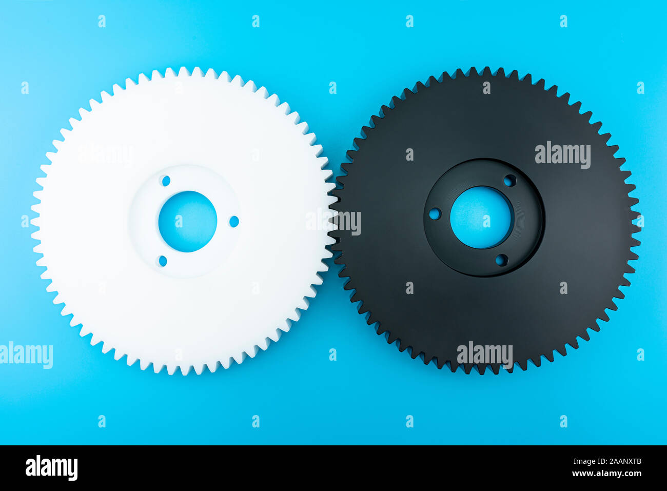 Connected black and white plastic gear with 68 sprockets on a blue ...