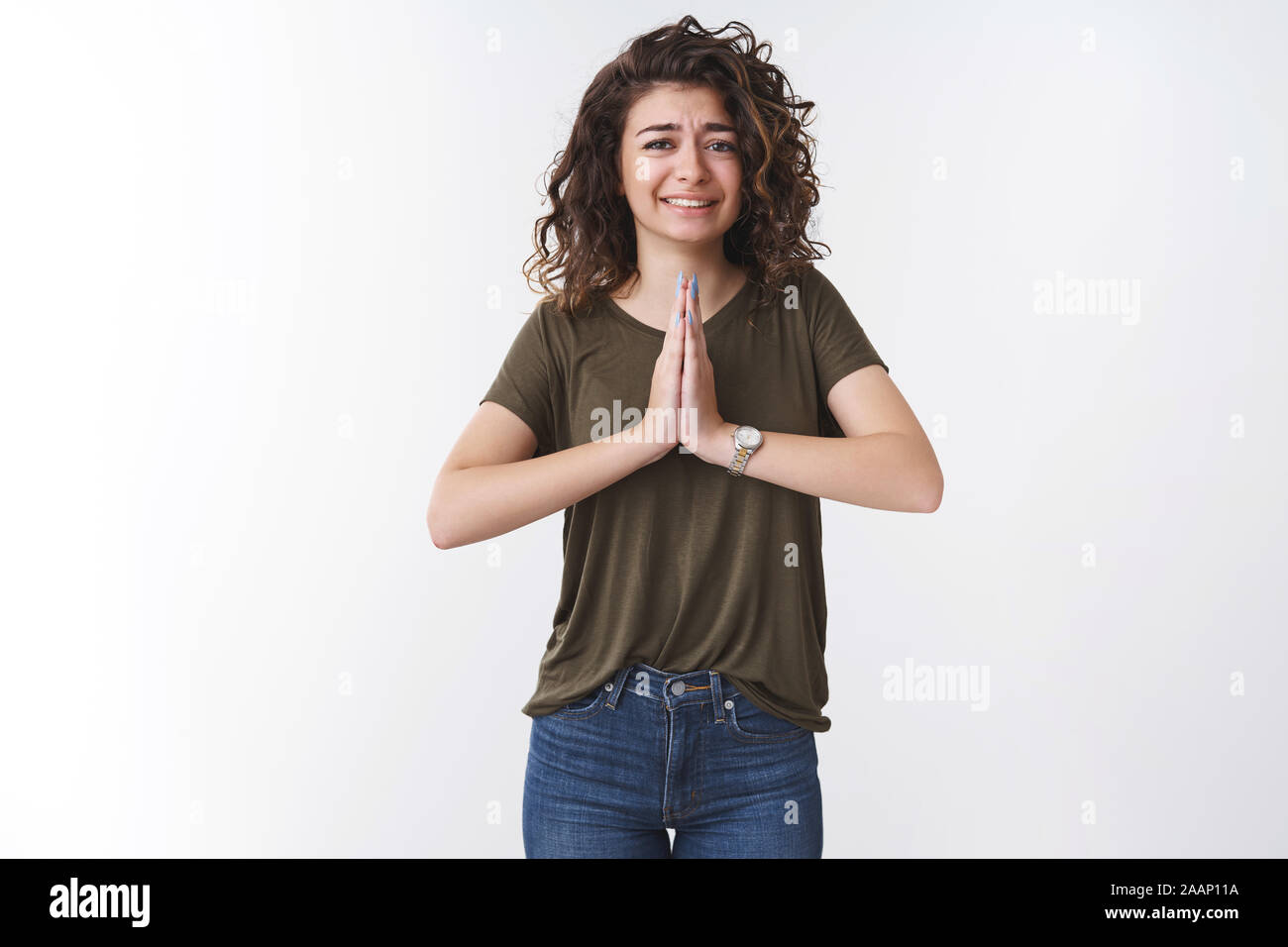 Nervous cute begging young girl press palms together pray say please ...