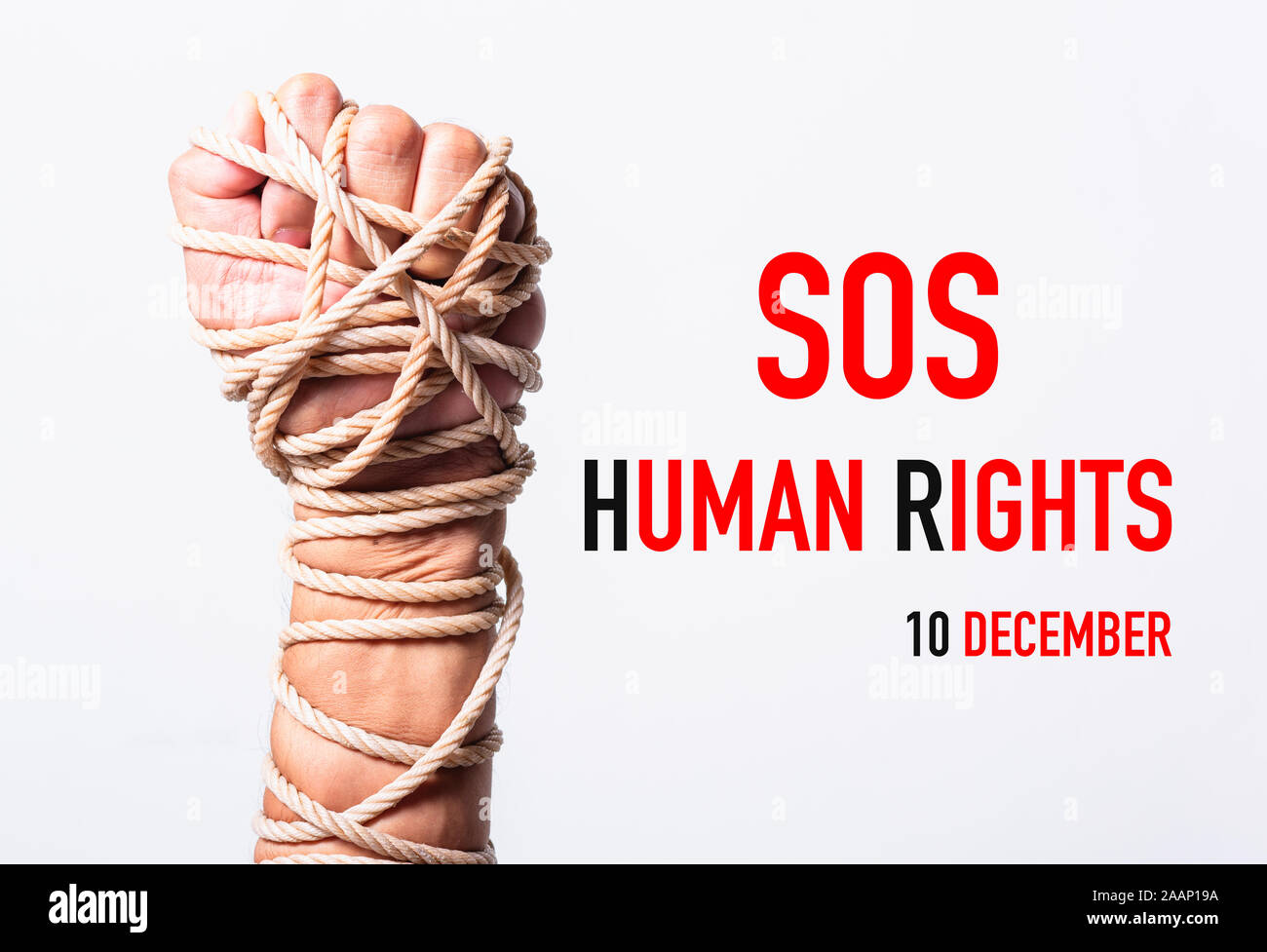 Rope on fist hand with SOS HUMAN RIGHTS DAY 10 december text on white ...
