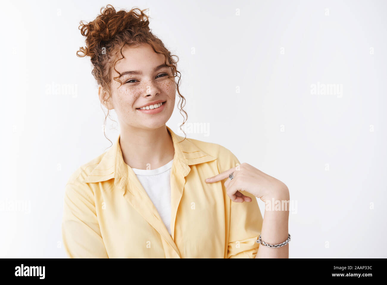 Skillful talented good-looking ginger girl freckles messy bun proudly ...