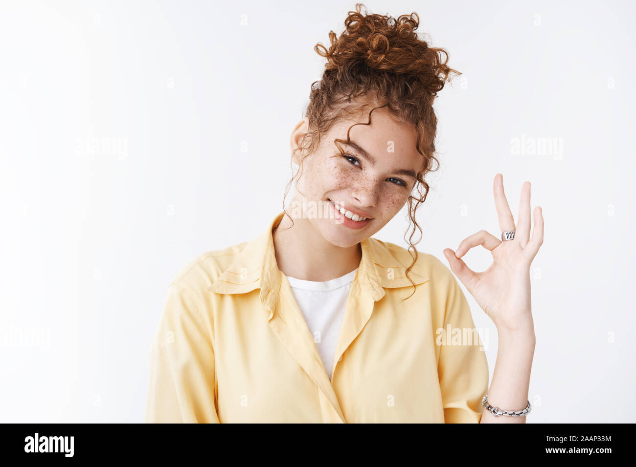 Portrait happy satisfied charming ginger girl curly messy bun freckled ...