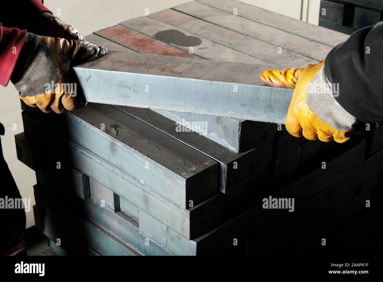 workers and heavy metal blocks Stock Photo - Alamy