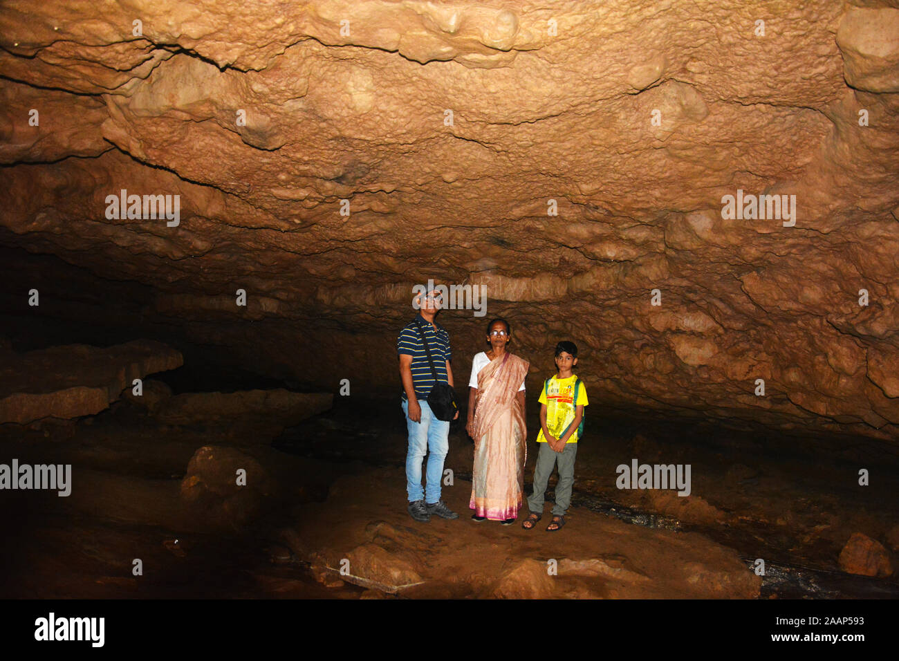 Close up of family, tourists in Stalactite rock caves of Cherrapunjee ...