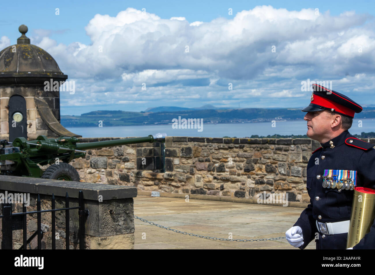 District Gunner and the One O'clock gun, Edinburgh castle over looking ...