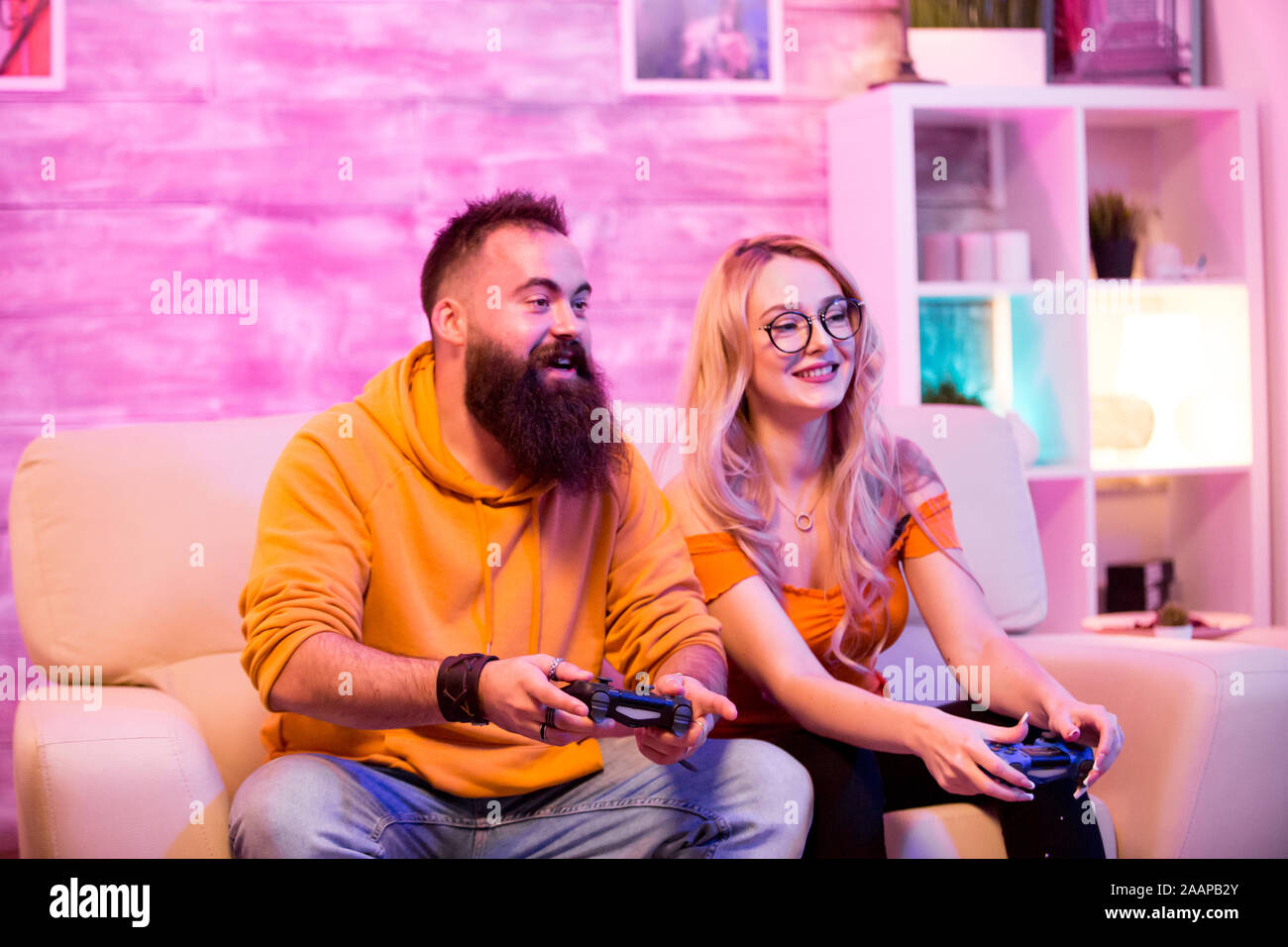 Older brother playing online games with his little sister in living ...