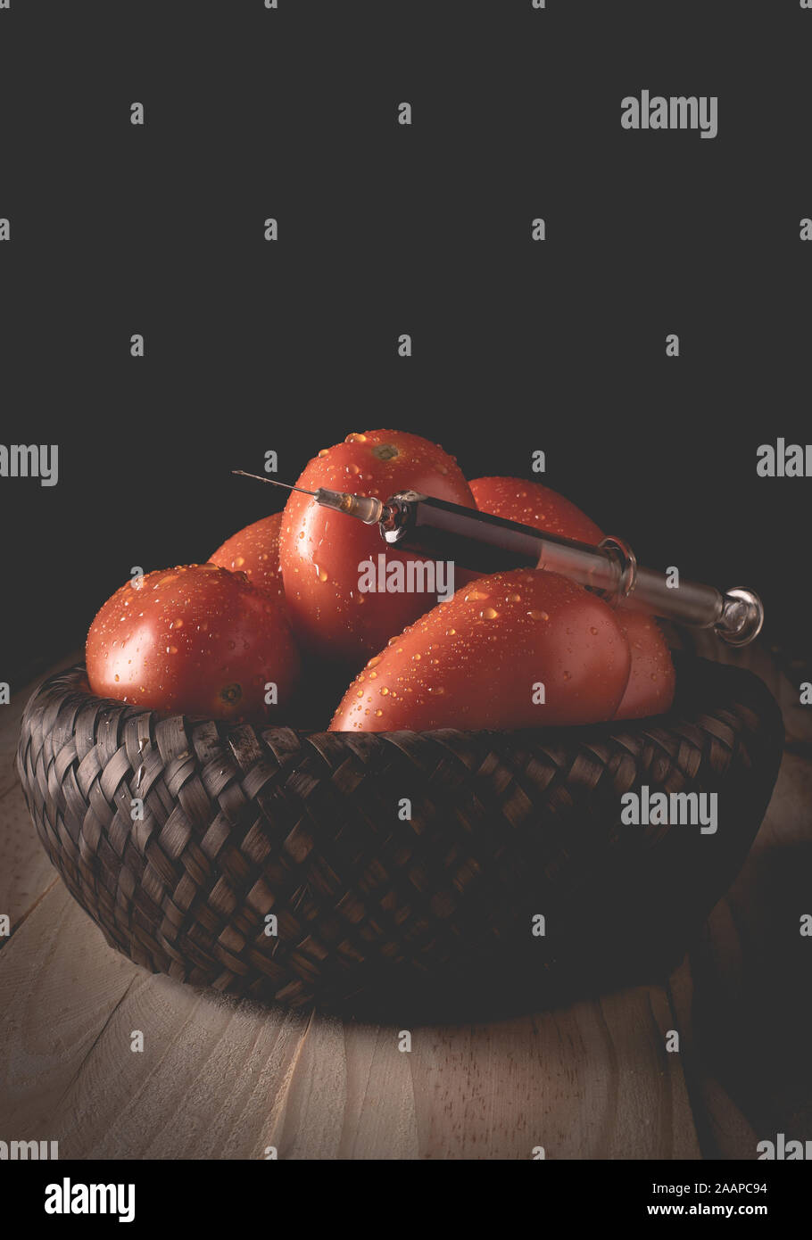 Injection of poisonous toxin into an organic tomato Stock Photo - Alamy