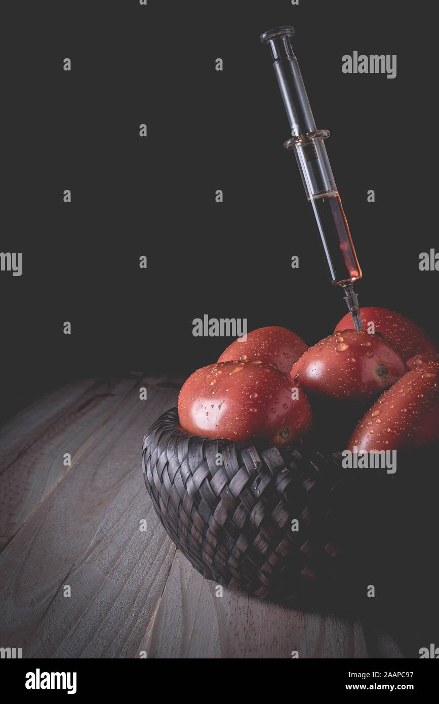 Injection of poisonous toxin into an organic tomato Stock Photo - Alamy