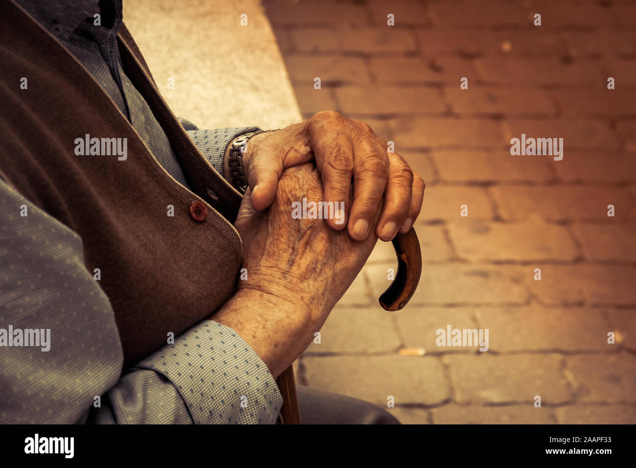 Old man holding walking stick hi-res stock photography and images - Alamy