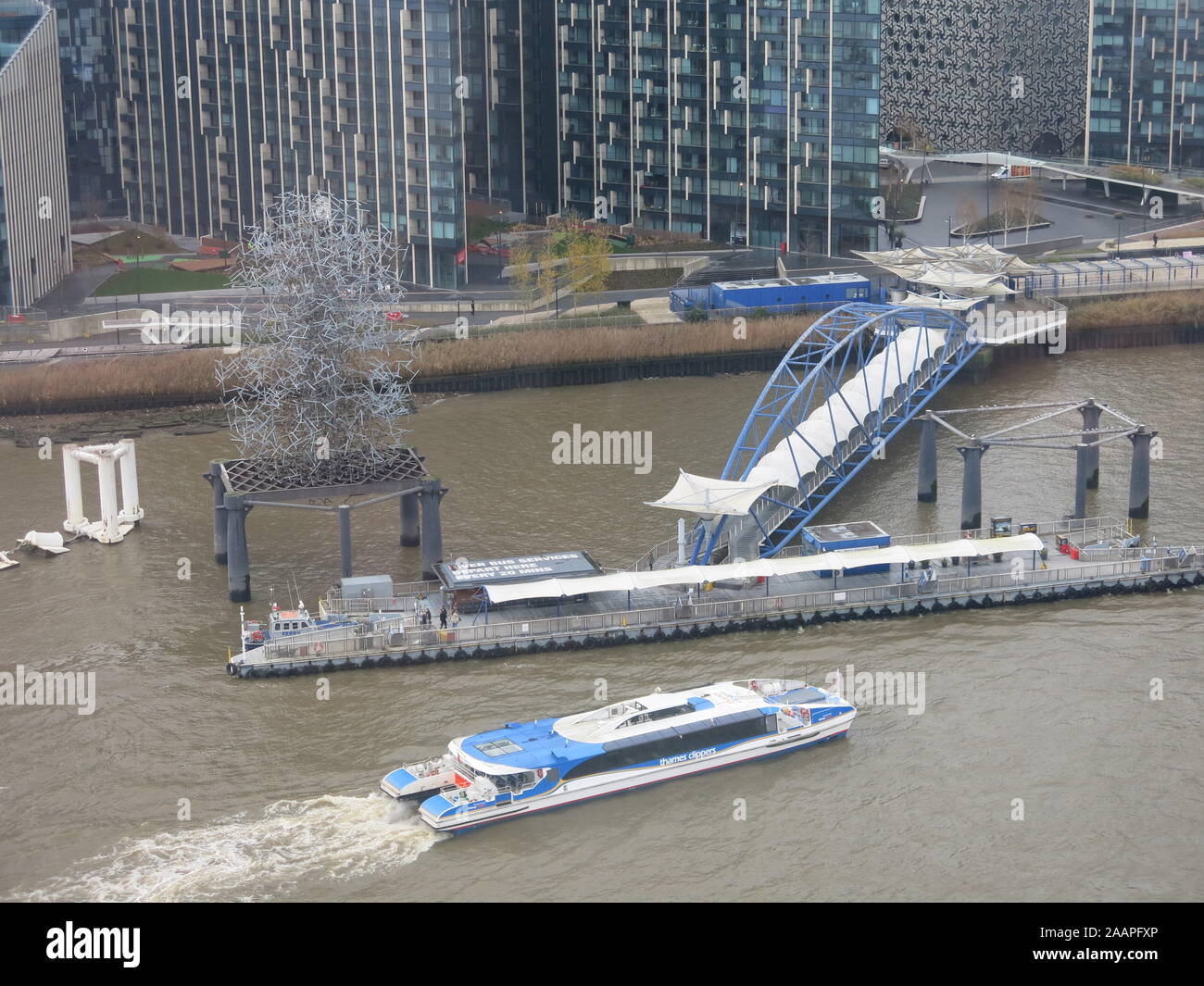Aerial view of North Greenwich pier with an approaching tourist boat ...