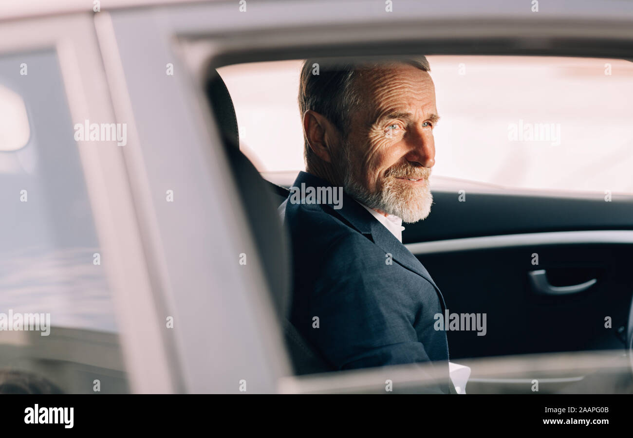 Side view of a man sitting in a car and looking out of the window Stock ...