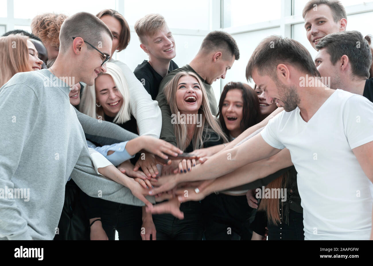 large group of young people joining their hands together Stock Photo ...