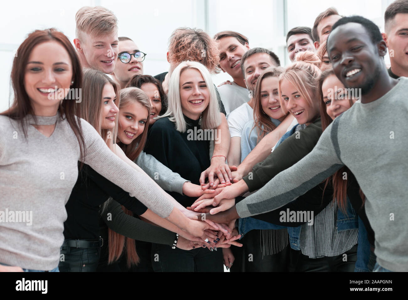 diverse young people putting their hands together Stock Photo - Alamy
