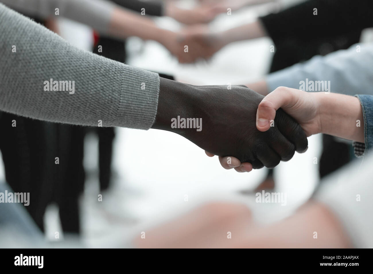 close up. diverse young people shaking hands with each other Stock ...