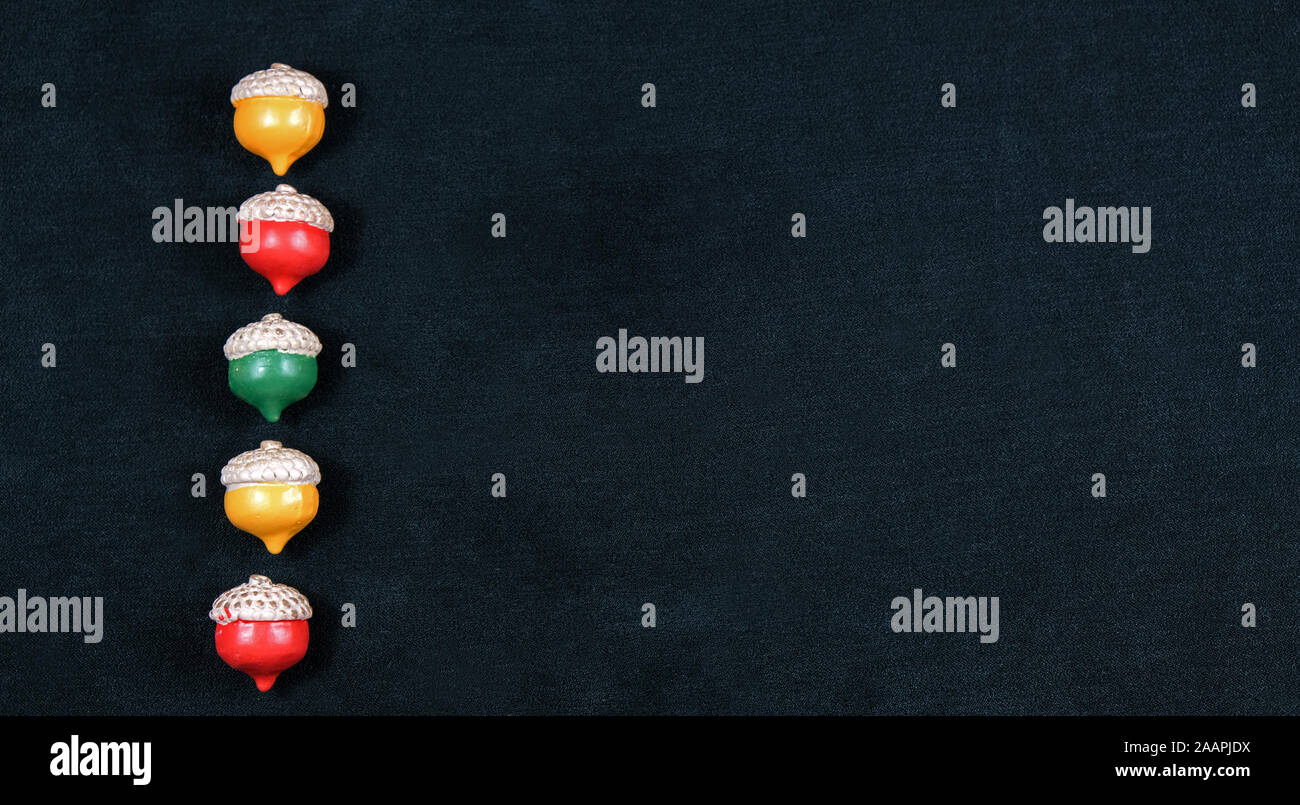 Colorful acorns in a straight line on the black background Stock Photo ...
