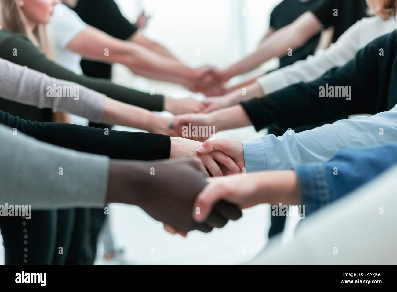 close up. diverse young people shaking hands with each other Stock ...