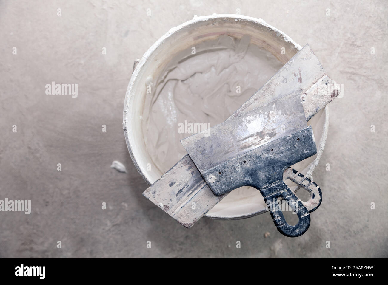 Decorative cement plaster and trowel in construction bucket ready for ...
