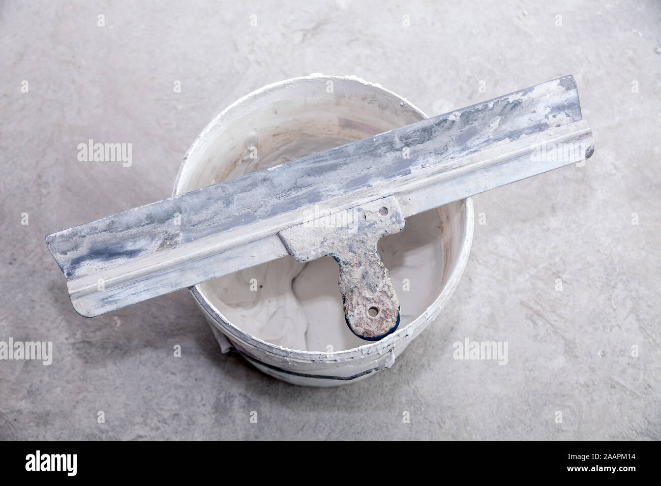 Decorative cement plaster and trowel in construction bucket ready for ...