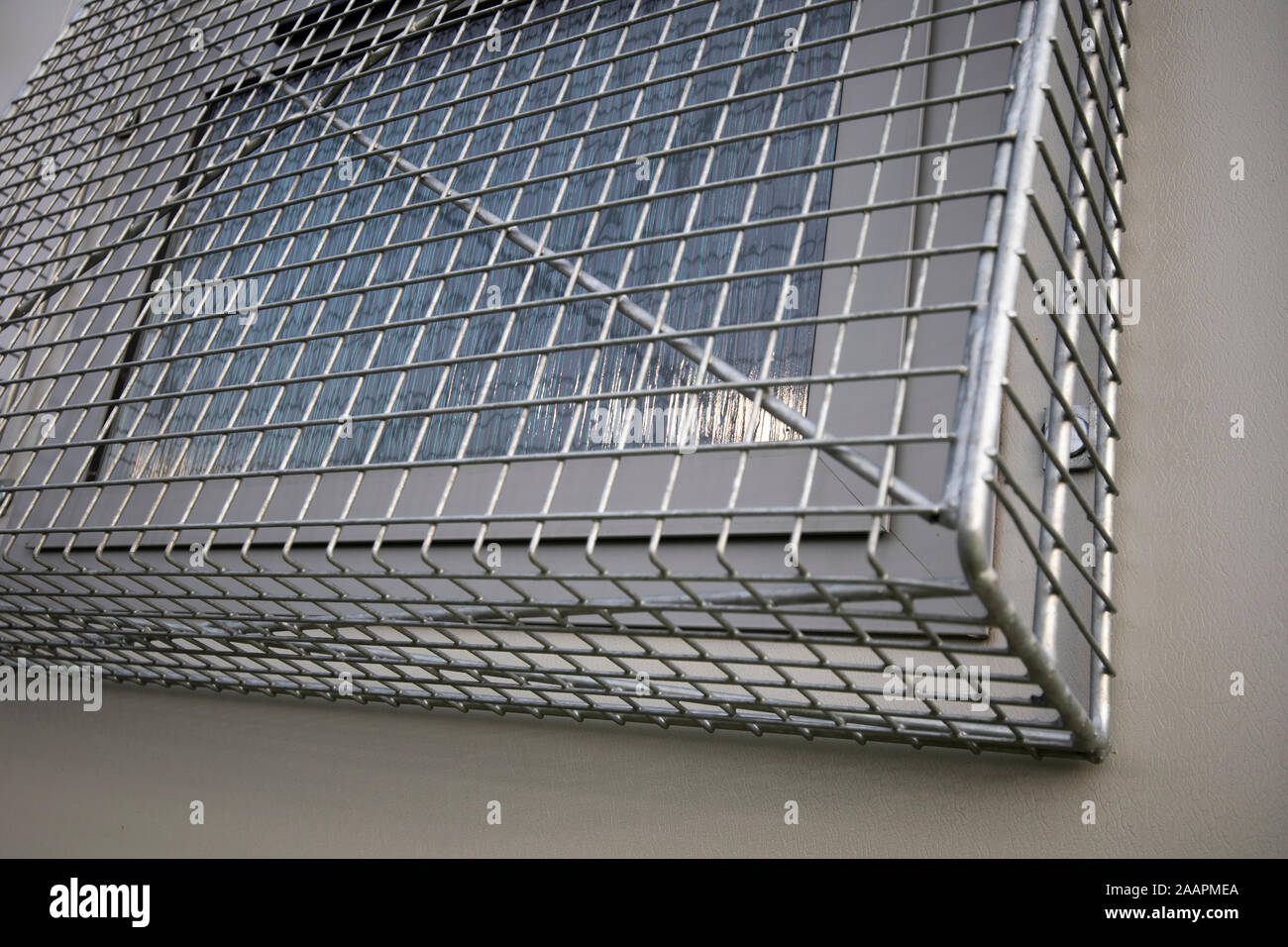 Window security wire mesh frame fixed externally to building wall to ...