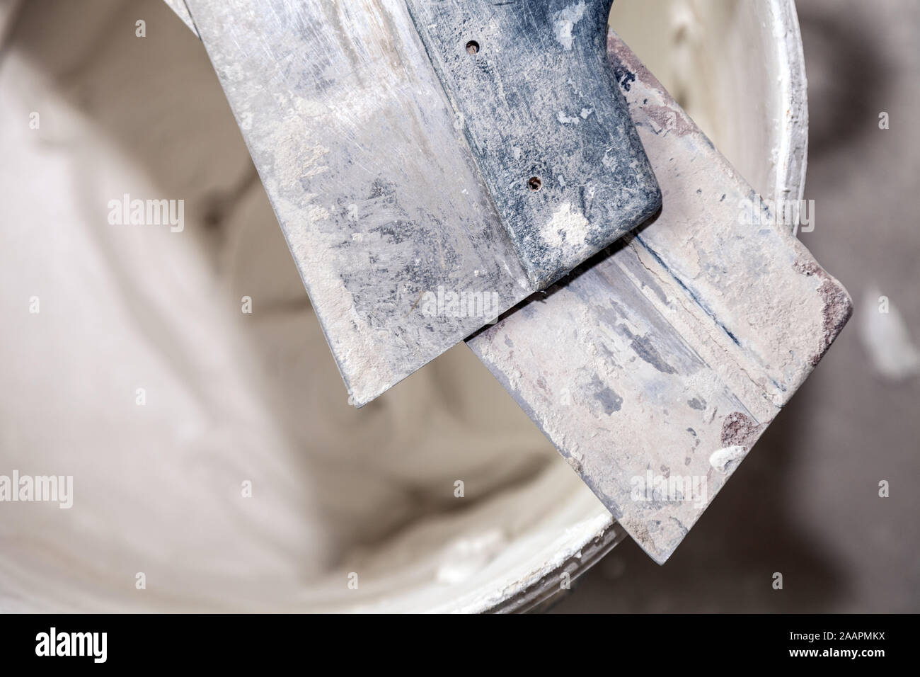 Decorative cement plaster and trowel in construction bucket ready for ...