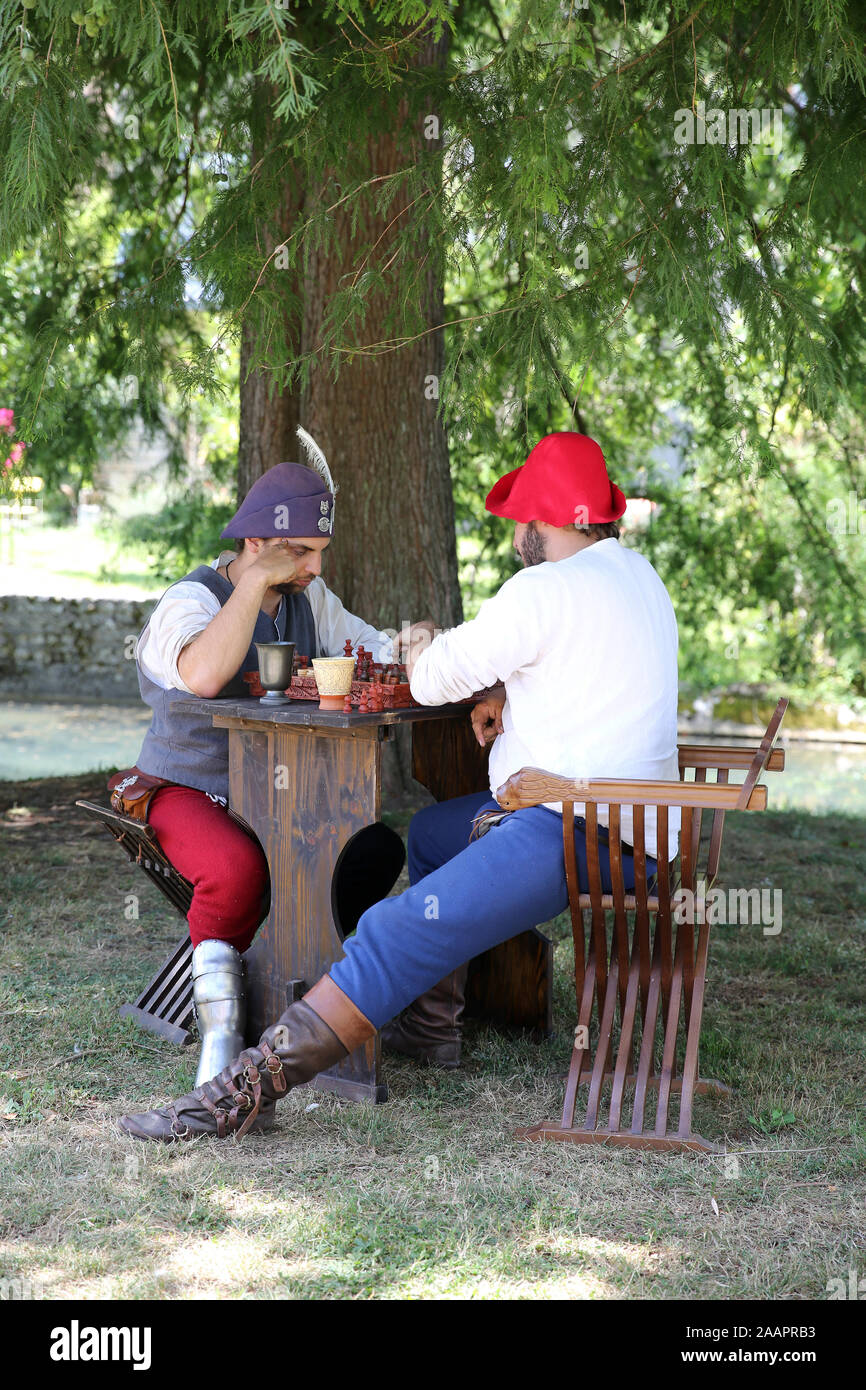 2 men in medieval costume having lunch Stock Photo - Alamy