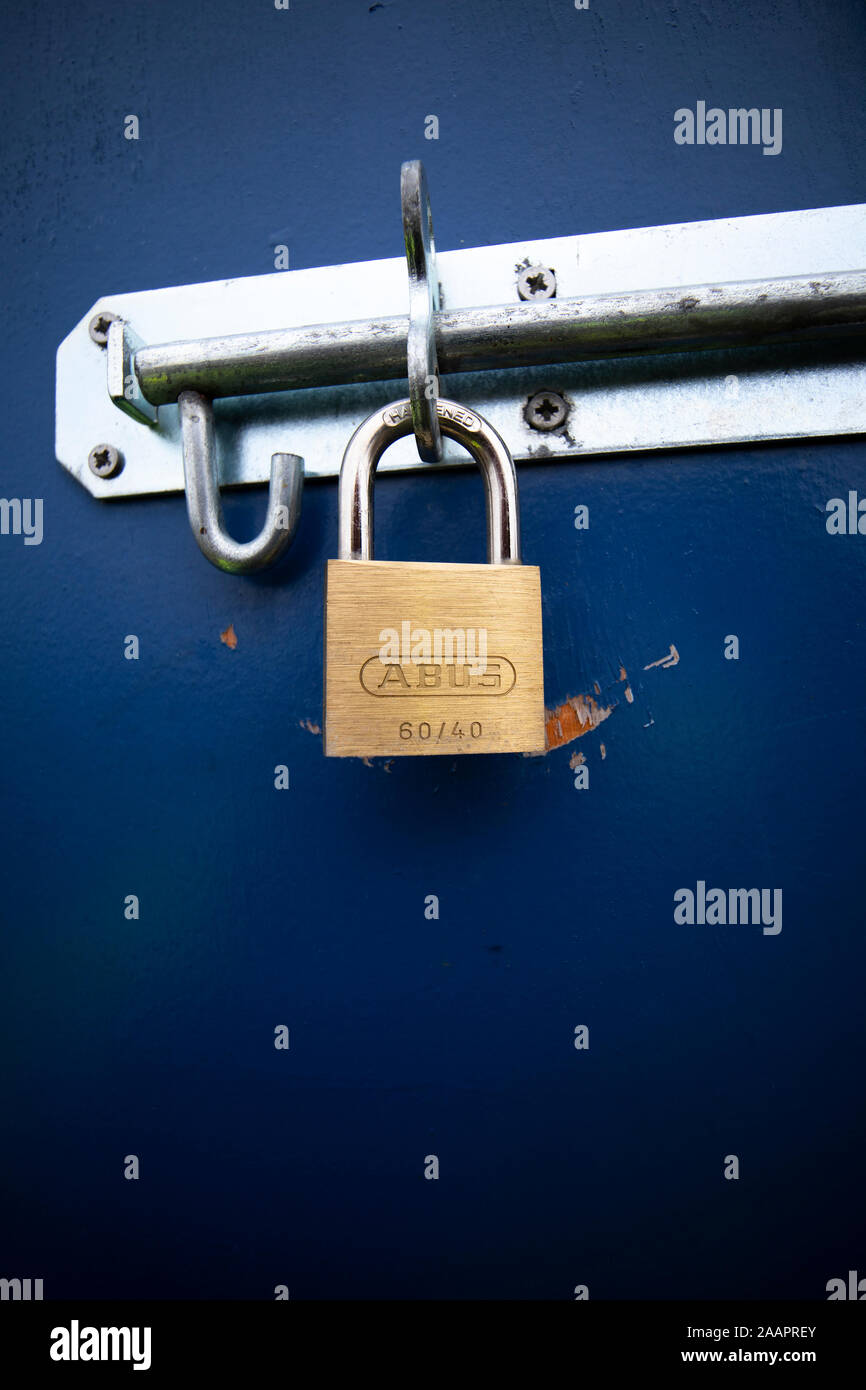 padlock and bolt fixed to timber door providing security to building ...