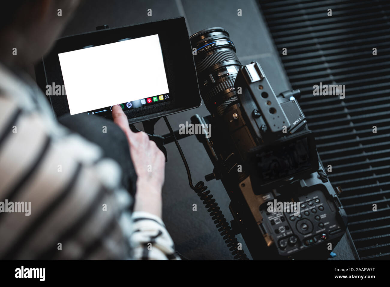 Hand of the camera operator touching a modern camera empty display ...