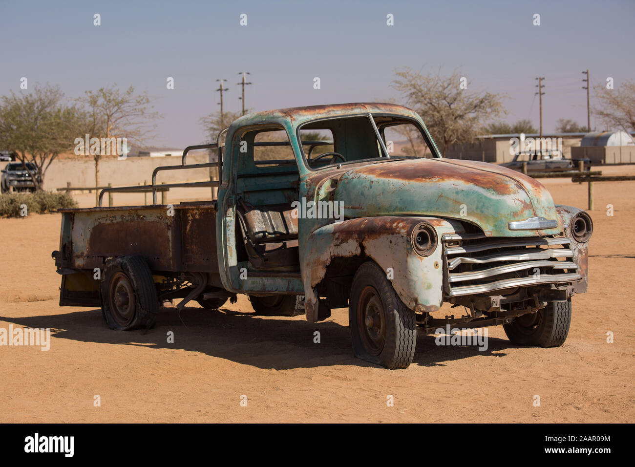 Abandoned old wrecked historic cars near a service station at Solitaire ...