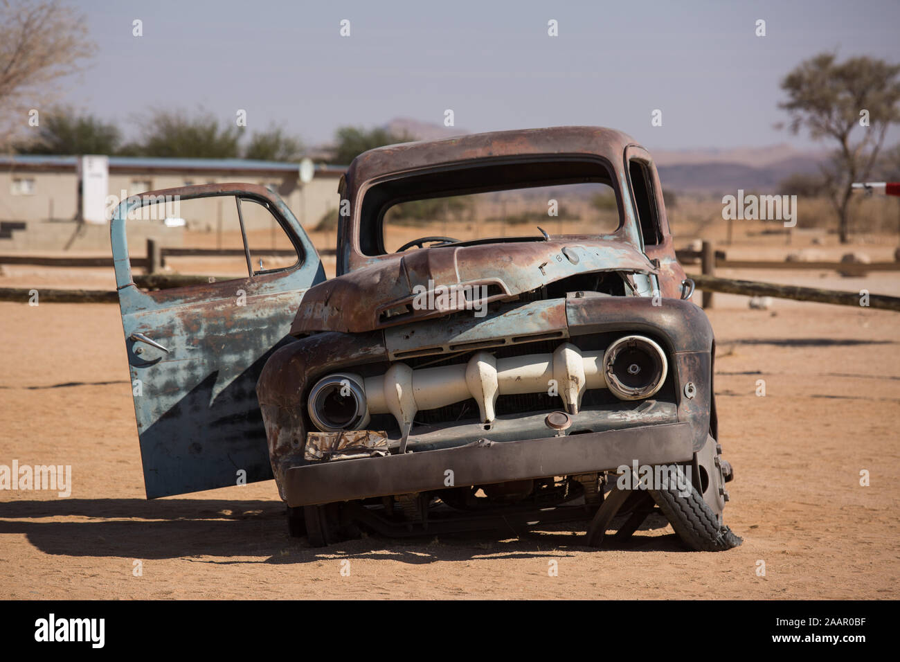 Abandoned old wrecked historic cars near a service station at Solitaire ...