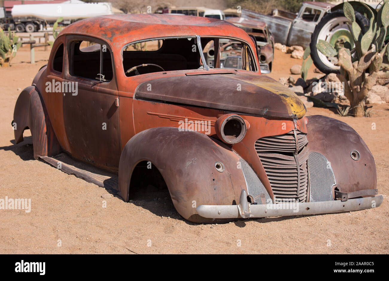 Abandoned old wrecked historic cars near a service station at Solitaire ...