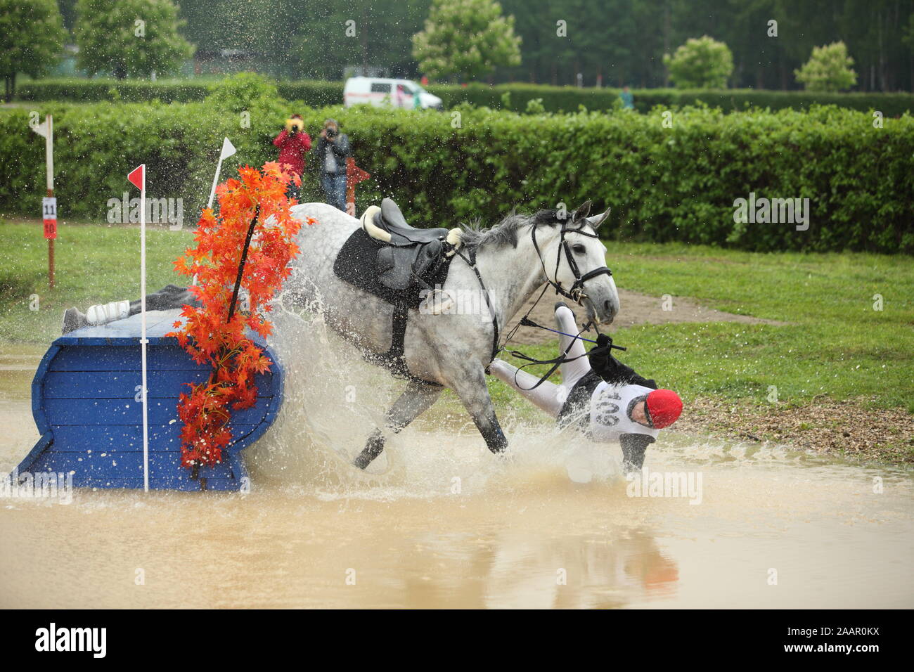 Cross country rider falling from horse, crashing out at the water jump ...