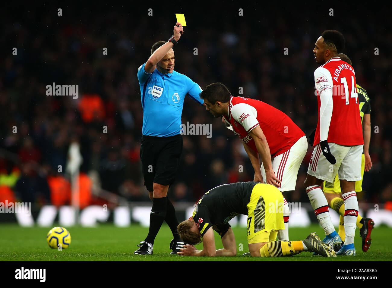 Referee stuart attwell shows a yellow card hi-res stock photography and ...