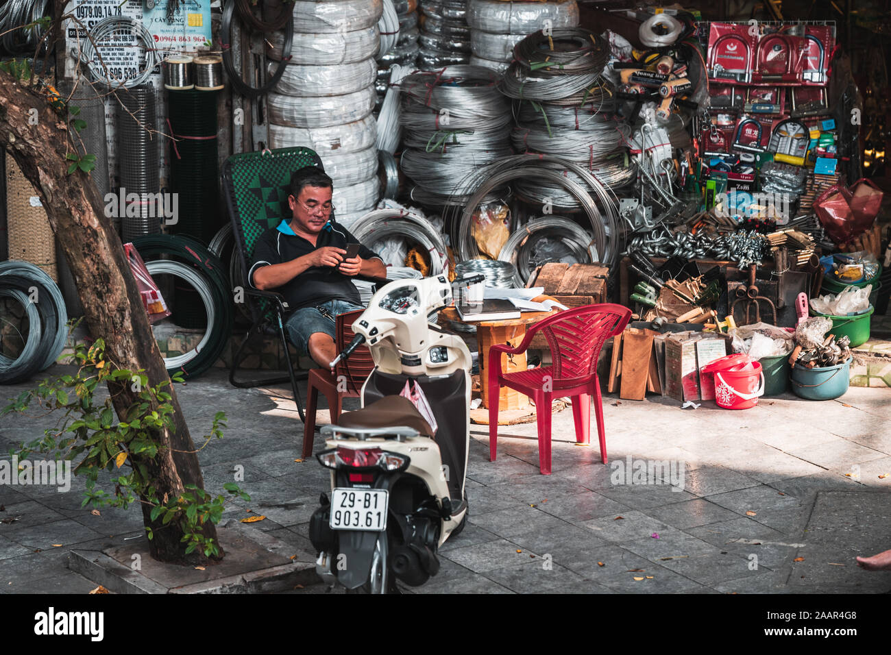 Hanoi, Vietnam - 12th October 2019: An Asian man sits slumped in a ...