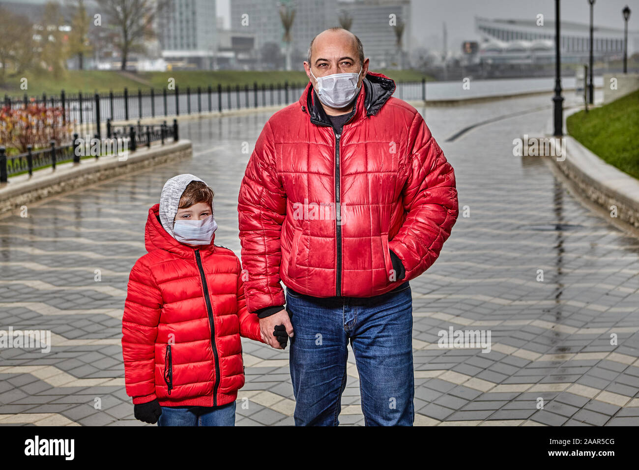 Father and son are warmly dressed in cold weather and wear protective ...