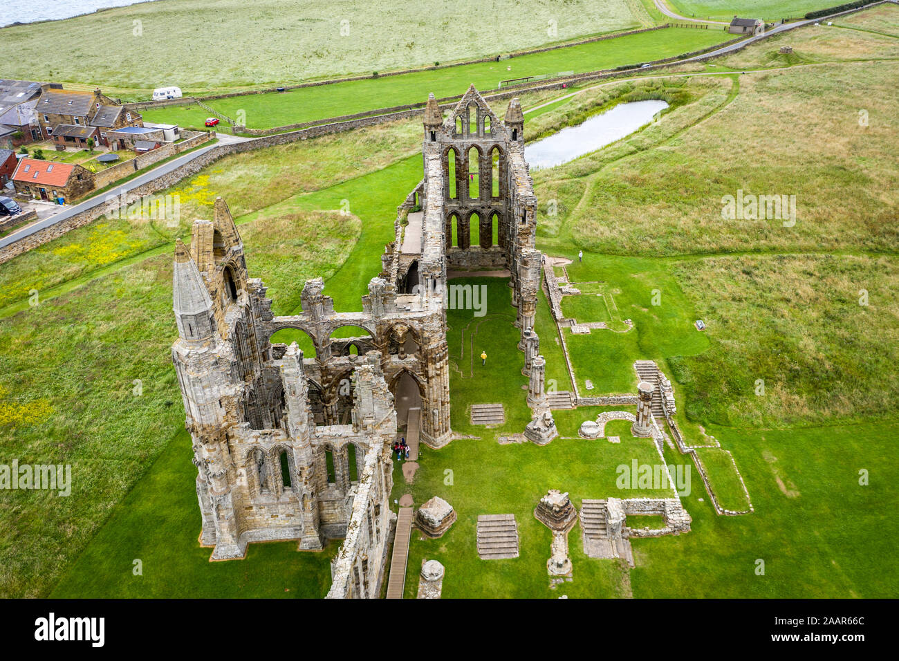 The iconic Whitby Abbey sits on the hill above the quaint English ...