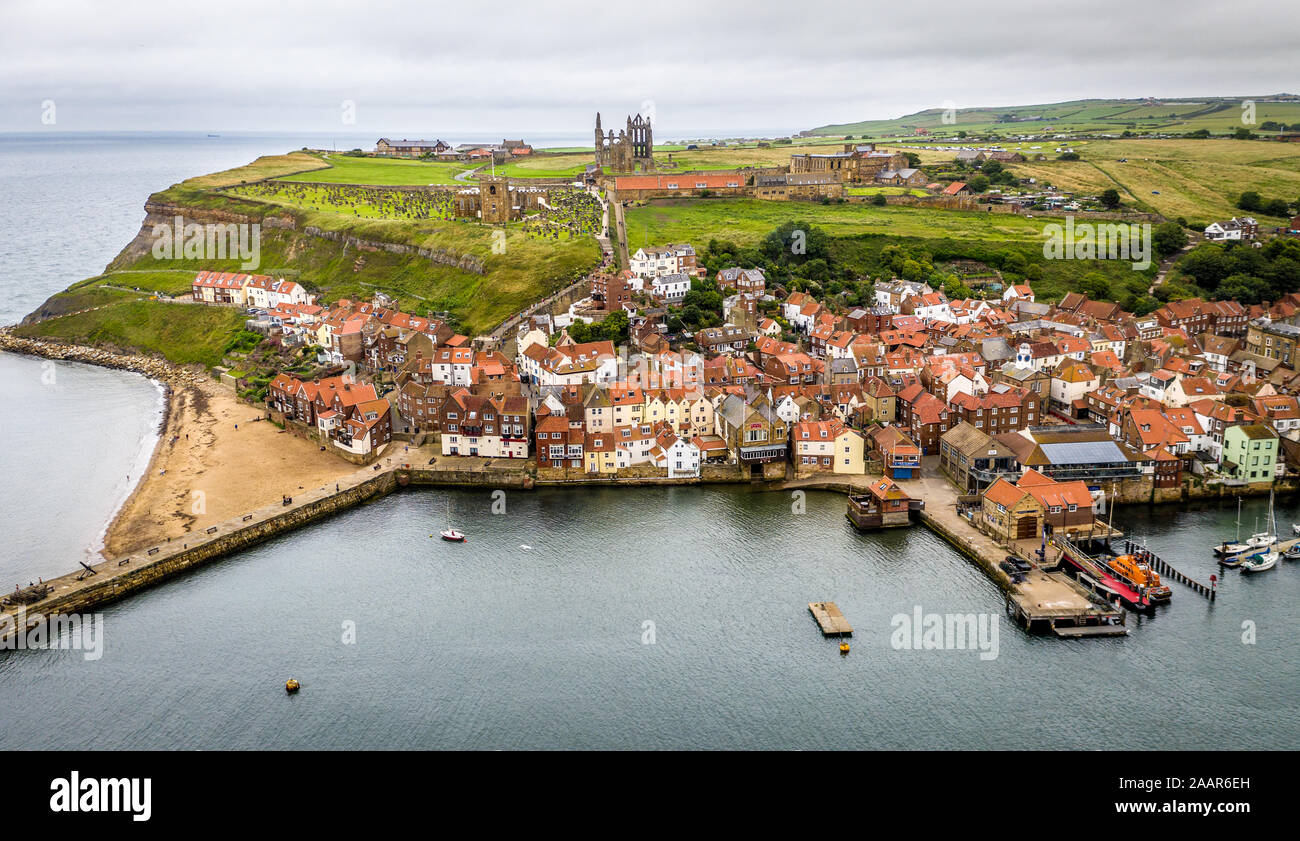 The iconic Whitby Abbey sits on the hill above the quaint English ...