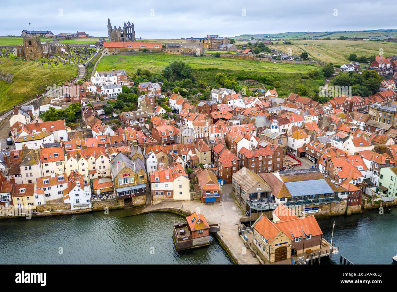 The iconic Whitby Abbey sits on the hill above the quaint English ...