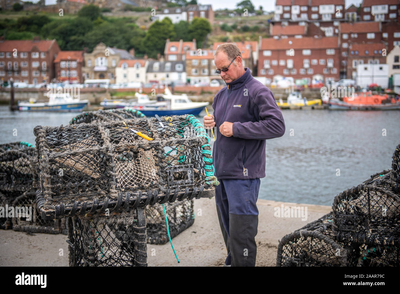 Fishermen repair their nets hi-res stock photography and images - Alamy