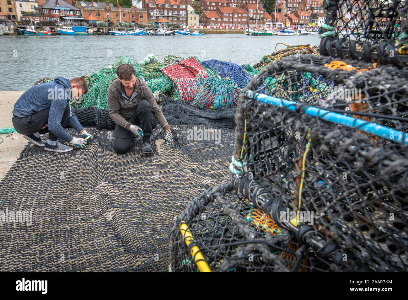 Fishermen repair their nets hi-res stock photography and images - Alamy