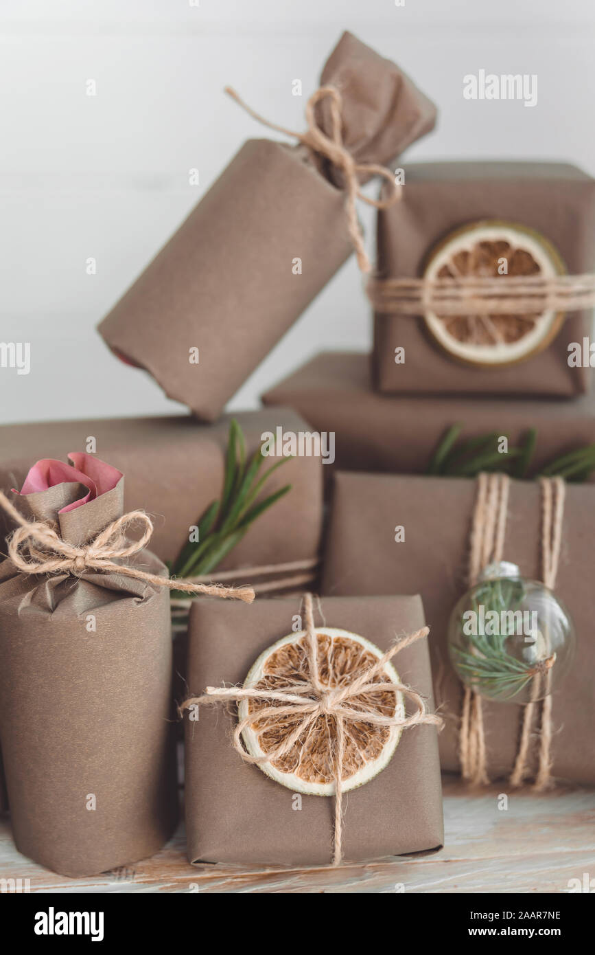 Pile of presents and gifts wrapped in craft paper with decoration on ...