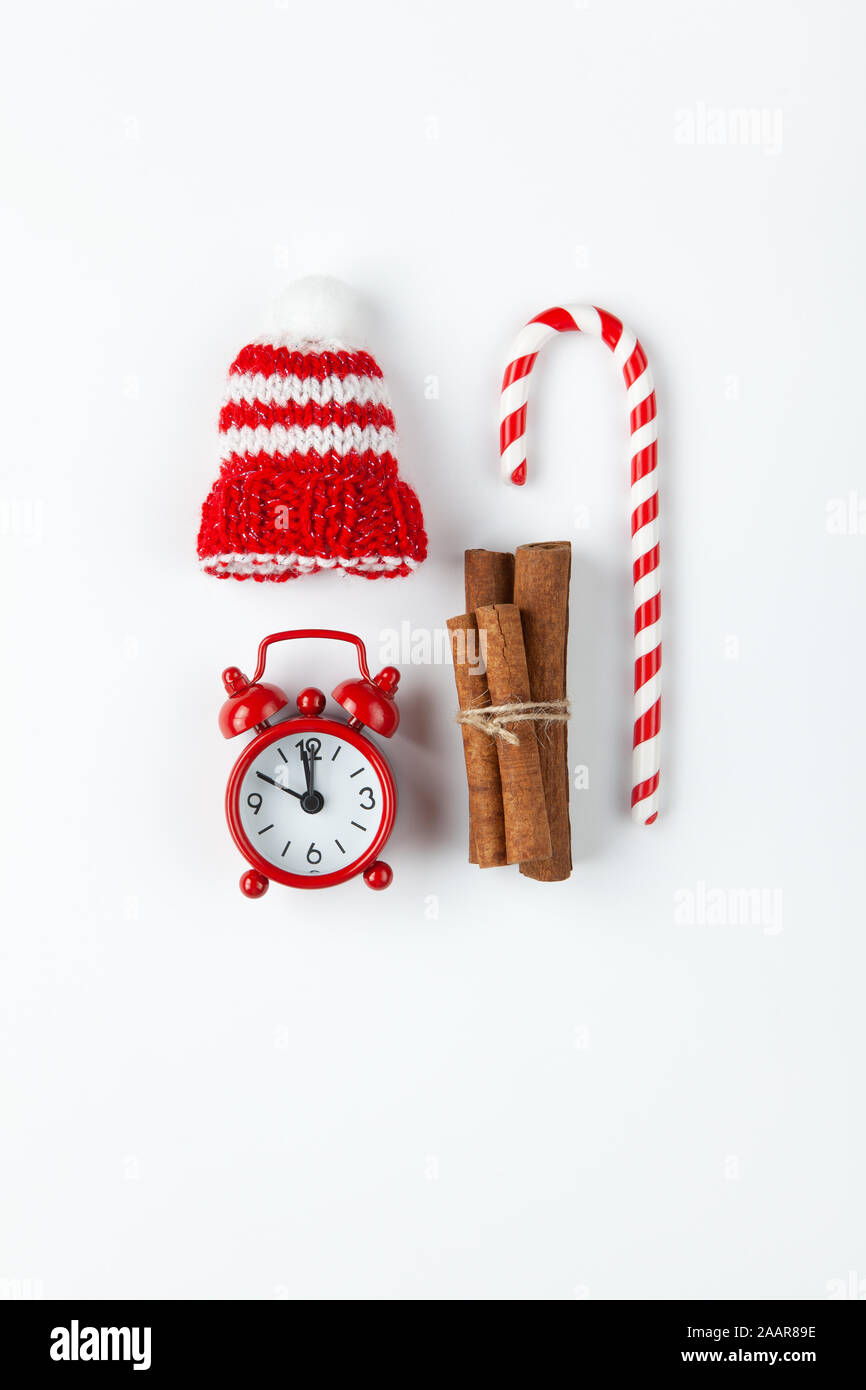 Christmas composition, cane candy, small analog clock, striped hat on ...