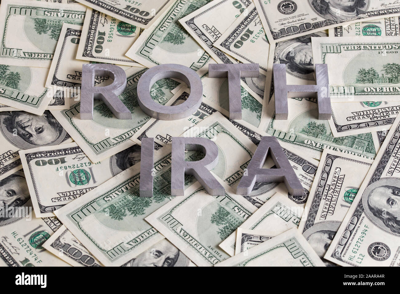 The words ROTH IRA laid with aluminium letters on the US dollar ...