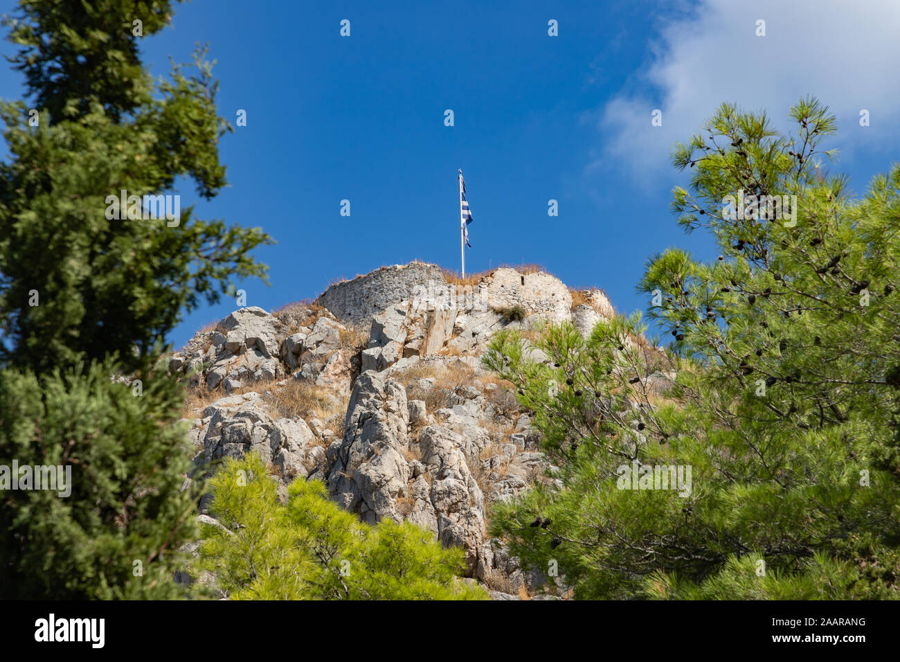 Greek flag and ruins over a mountain in Hydra Island, Greece Stock ...