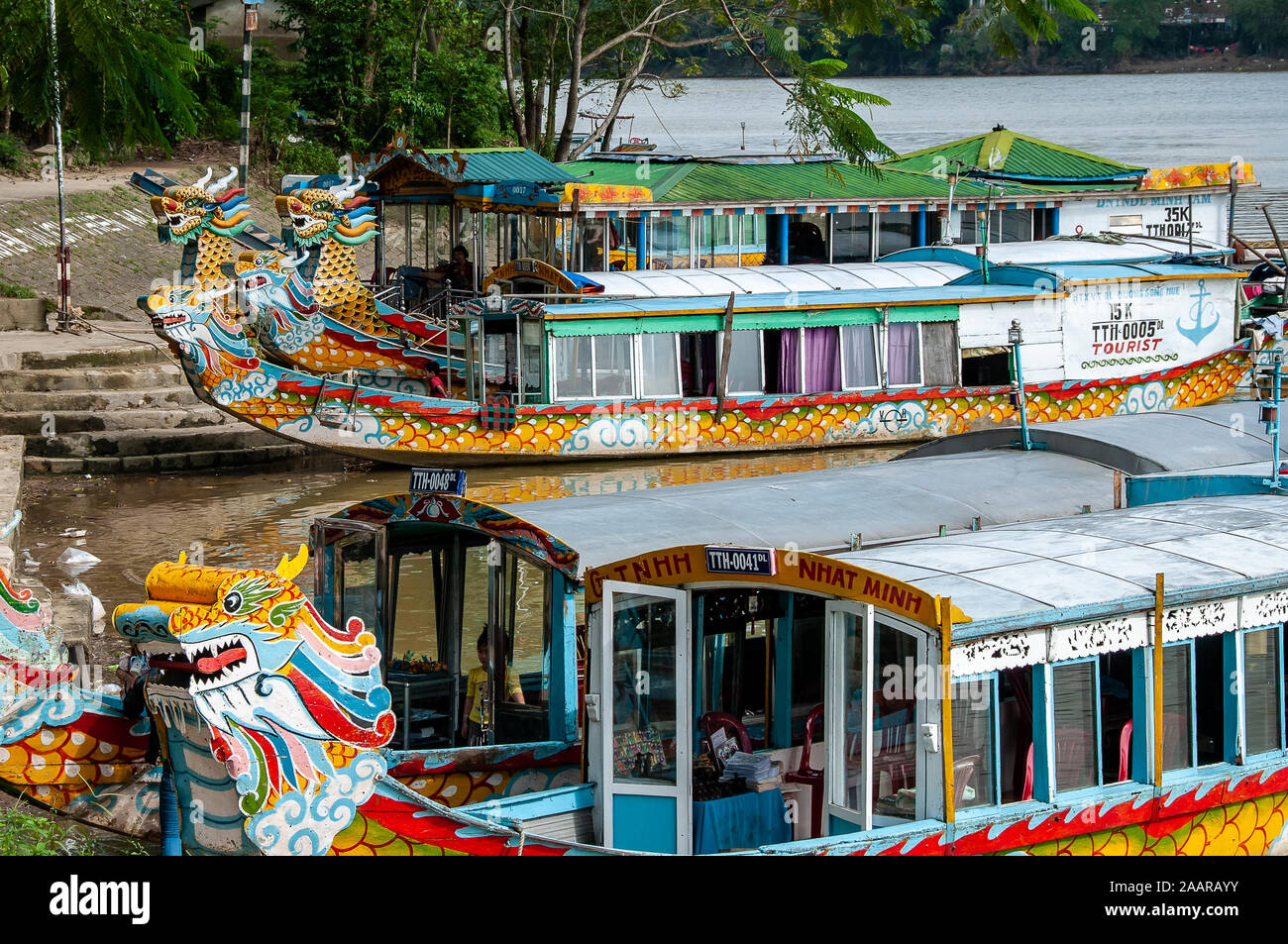 Colorful boats are used by tourists to get to the Pagoda of the ...